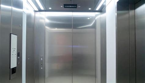 An Elevator In Modern Building With Stainless Steel Doors And White