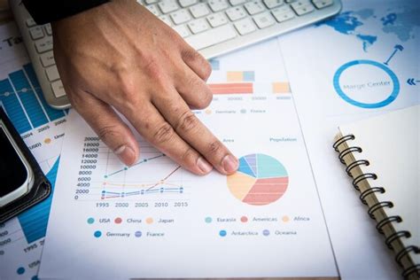 Premium Photo Close Up Of Businessman Pointing At Graph On Table