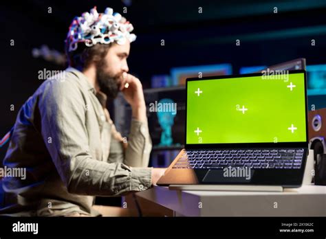 man with eeg headset on writing code to transfer mind into virtual