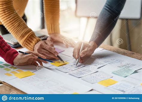 Group Of Ux Developer And Ui Designer Brainstorming About App Interface Design At Modern Office