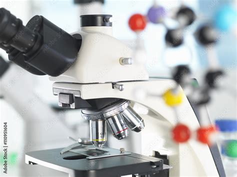 Microscope Viewing Sample With A Ball And Stick Molecular Model
