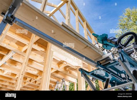 Wooden House Skeleton Frame Building Construction Industry Theme Powerful Wood Saw In Front Of