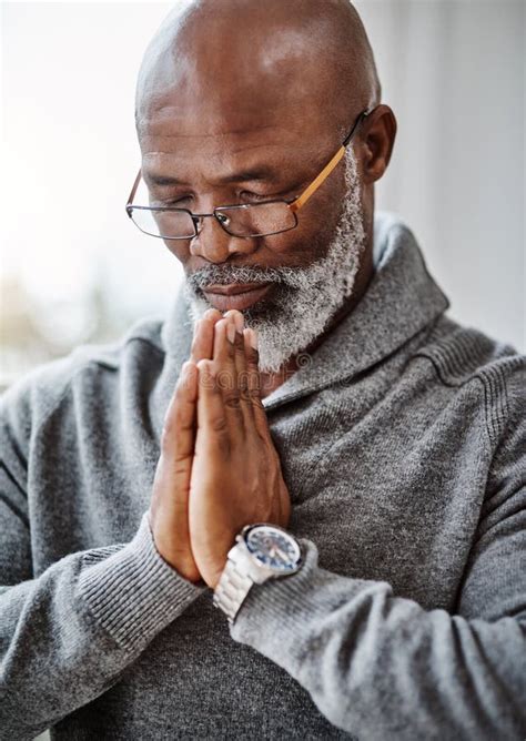 Prayer Helps Him Keep Going A Handsome Senior Man Praying In His Home