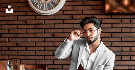 회색 블레이저와 회색 바지를 입은 여자가 갈색 의자에 앉아 있습니다 사진 Unsplash의 무료 초상 이미지