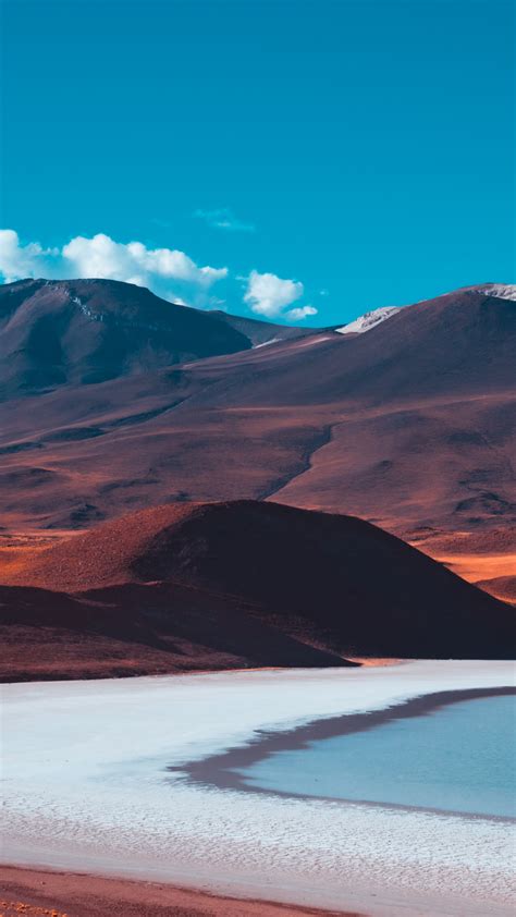 Red Volcanic Mountains And A Blue Salt Lake In Desert San Pedro De