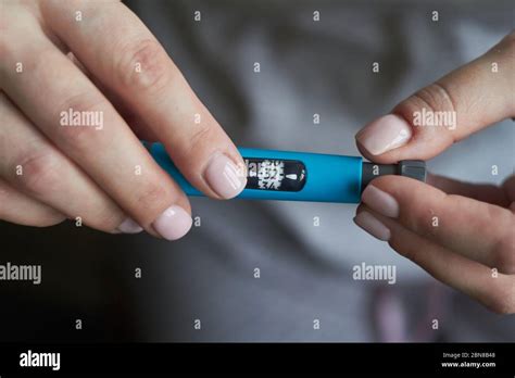 Diabetes Patient Turn Knob On End Of Insulin Pen And Dial Up Correct