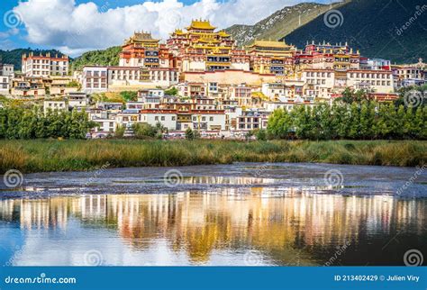 Songzanlin Monastery With Beautiful Water Reflection On Lake Shangri La