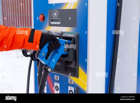 Man Holding DC Hpc Charging Connector In Hand Electric Vehicle CCS Lidl Quick Charge Station