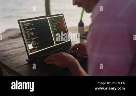Focused Man Codes Software Near Sea Blends Work And Leisure Male Developer Programs On Laptop