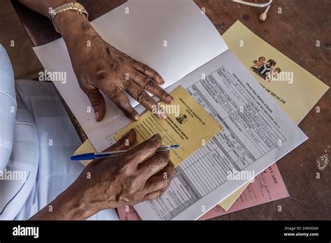 Nurse Filling Out Healthcare Forms For A Pregnant Woman Photographed