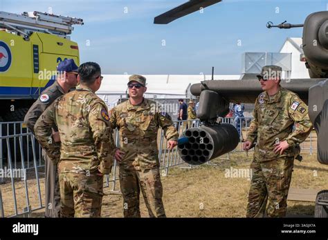 Australian And Us Army Pilots Seen Next To Apache Ah 64 Combat Helicopter During A Press Event