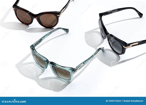 Set Of Stylish Sunglasses With Bright Sunlight On White Background