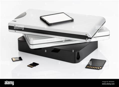 group of external hard disks and memory cards on white table data