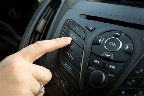 Premium Photo Closeup Of Female Finger Pressing Radio Button On Car Control Panel