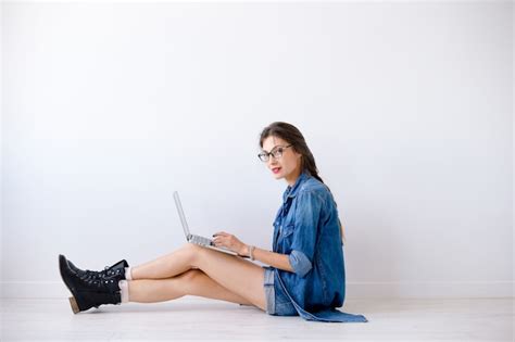Free Photo Attractive Woman Typing On Laptop While Sitting On Floor