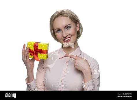 Happy Smiling Blond Woman Poiting At Gift In Her Hand Stock Photo Alamy