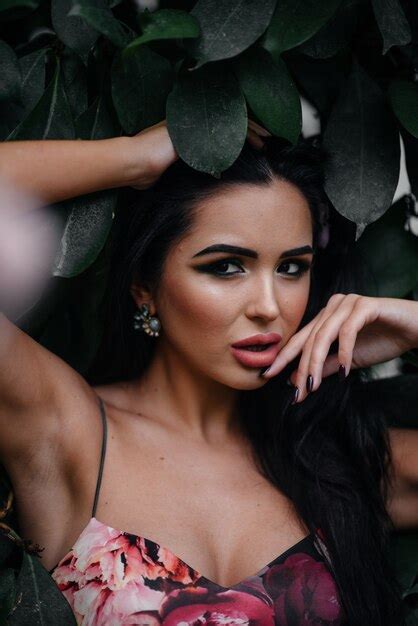 Premium Photo A Young Beautiful Brunette Posing Among Dense Thickets