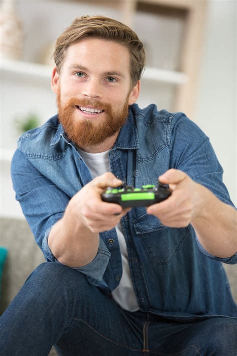 Attractive Young Man Using Joystick Or Joypad For Videogames Stock