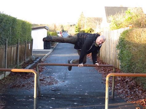 Premium Photo Full Length Of Man Jumping Over Railing On Road In City
