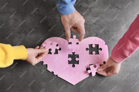 Premium Photo Group Of People Completing Puzzle Together On Gray Background Unity Concept