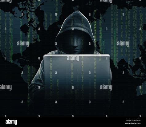 Hacker In Black Hoodie Holding Laptop With His Hand And World Map With Binary Code Over Dark