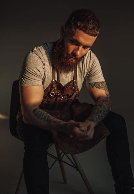 Premium Photo Thoughtful Barber Sitting On Chair