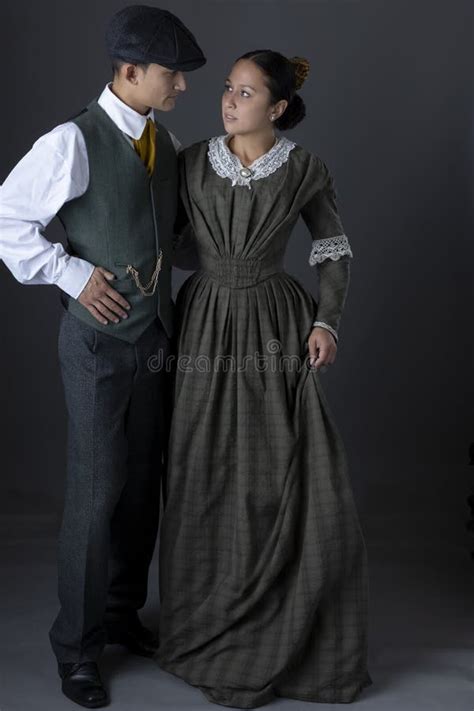 A Romantic Working Class Victorian Couple Standing Together Against A
