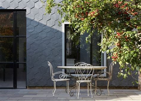Slate House Is An Extension Clad With Hexagonal Tiles