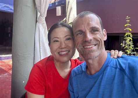 Year Old Caucasian Husband And His Year Old Korean Wife Posing In A Garden In Cabo San
