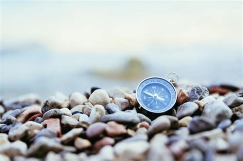 Premium Photo Navigation Concept Compass Is Lying On The Beach Near The Sea