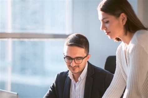 Premium Photo Man Data Analyst And Woman Manager Focused On Screen And Working Together In A