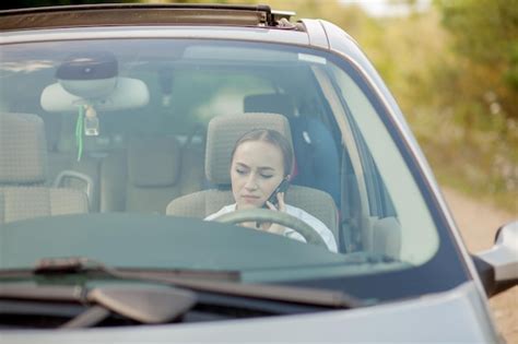 Premium Photo Portrait Shot Through Windshield Of Pretty Woman In Car