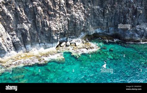 Large Rock Formations That Look Like Los Gigantes Right On The Ocean On
