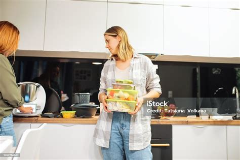 여자는 식료품이 든 플라스틱 상자를 들고 현대 전자 주방 가전을 본다 친구들은 집에서 함께 요리합니다 여자에 대한 스톡 사진 및 기타 이미지 Istock