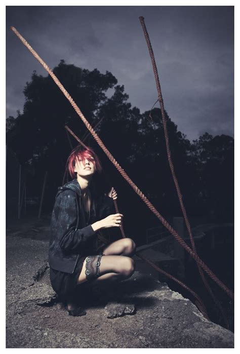 A Woman With Red Hair Sitting On The Ground