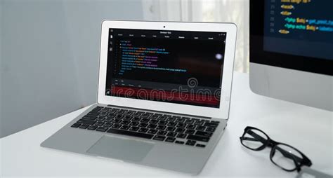Programming Code On Laptop Monitor And Beside Screen Pc Desktop Tastemaker Stock Photo Image