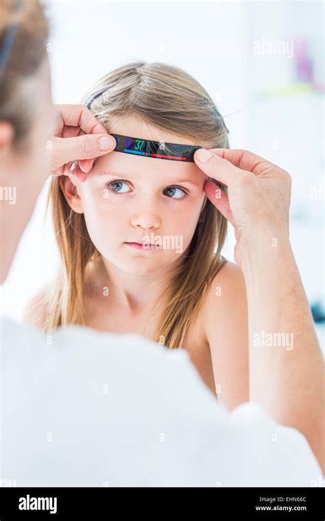 Measuring Body Temperature Using A Strip Thermometer Stock Photo Alamy