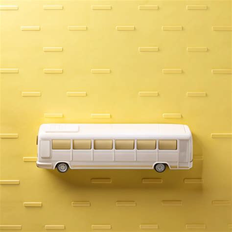 A White Bus With Yellow Squares On The Front And The Number 8 On The