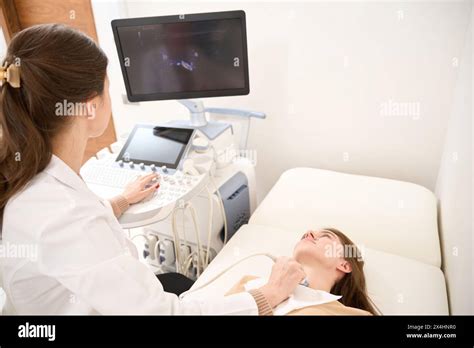 Doctor Doing Ultrasound Scan Of Woman Thyroid Gland And They Looking At Monitor Stock Photo Alamy