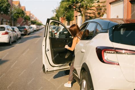 Premium Photo Rear View Of A Woman Getting Into A Car
