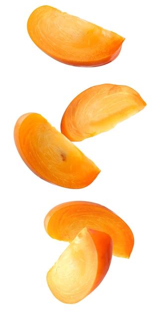 Premium Photo Falling Pieces Of Persimmon Isolated On A White