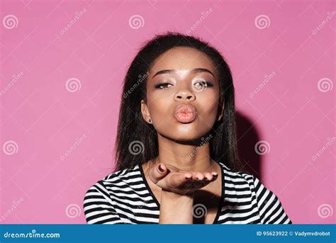 Portrait Of A Beautiful African Woman Blowing Kiss To Camera Stock