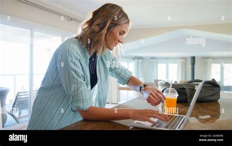 Casually Dressed Young Woman Downloading Data From Smart Watch Personal
