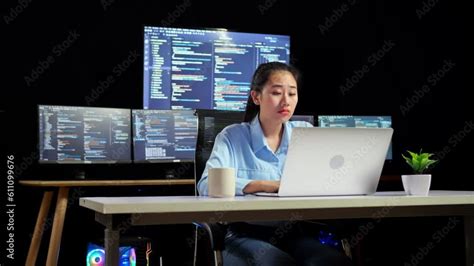 asian female programmer yawning and sleeping while writing code by a