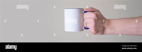 White Mug In The Hands Of A Man On A Light Background The Concept Of Delicious And Hot Coffee