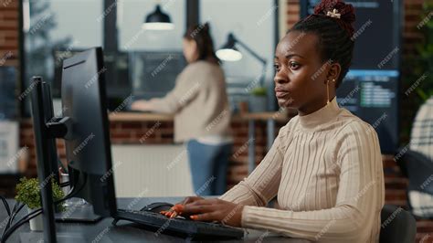Premium Photo | African american software engineer working focused ...