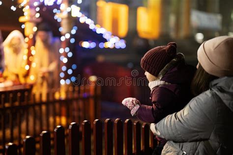 Mother With Daughter Against Scene Where The Virgin Mary Gave Birth To