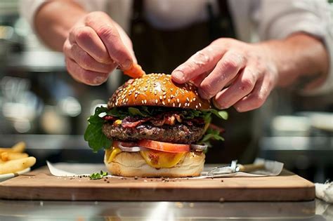 Premium Photo A Burger Being Assembled With Homemade Ingredients