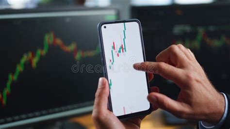 Trader Hands Holding Smartphone Displaying Data Of Stock Trading Charts Closeup Stock Video
