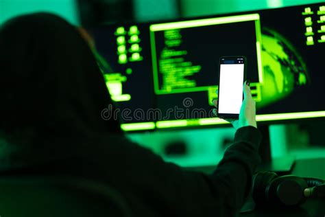 Hacker Using Smartphone In Dimly Lit Cyber Security Environment Stock